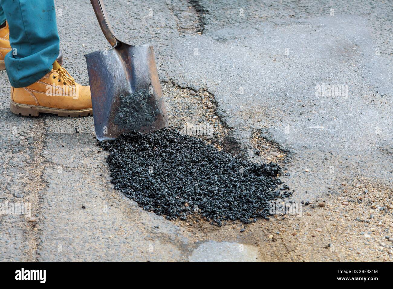 Laying new asphalt, covering the pit, hole in asphalt with very bad ...