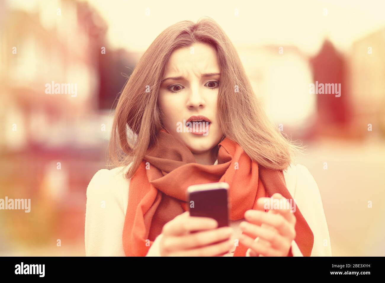 SMS. Closeup portrait funny shocked anxious scared young girl looking ...