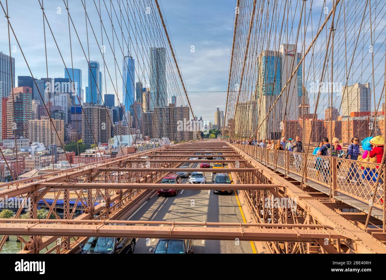 Manhattan through the Brooklyn Bridge cables in New York Stock Photo ...