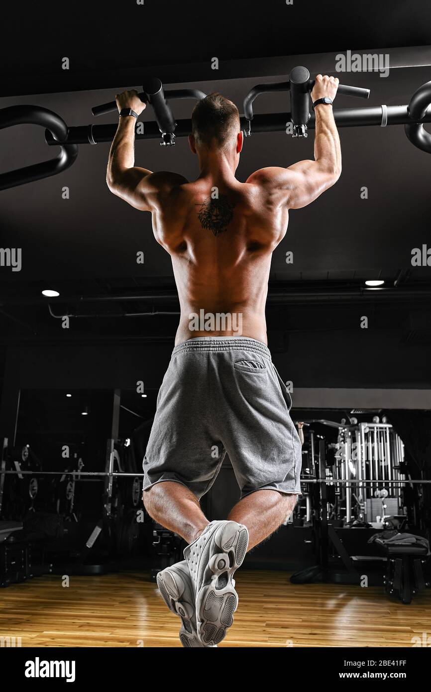 The athlete does a pull-up on the horizontal bar. A man in great shape ...