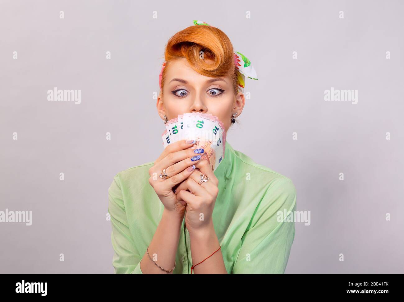 Money. Closeup red head beautiful young woman pretty excited amazed ...