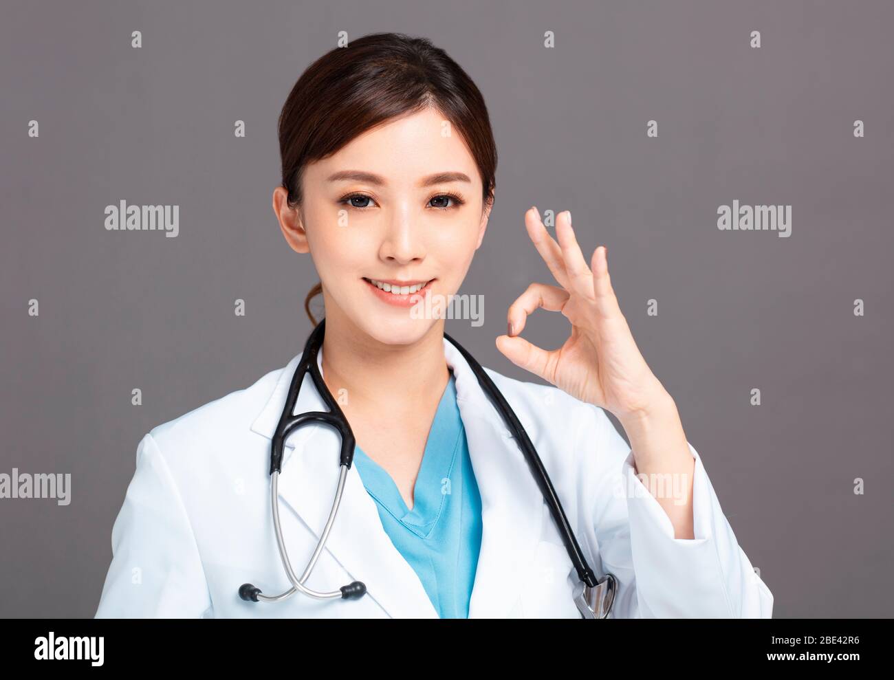 Smiling asian female doctor hand with ok sign Stock Photo - Alamy