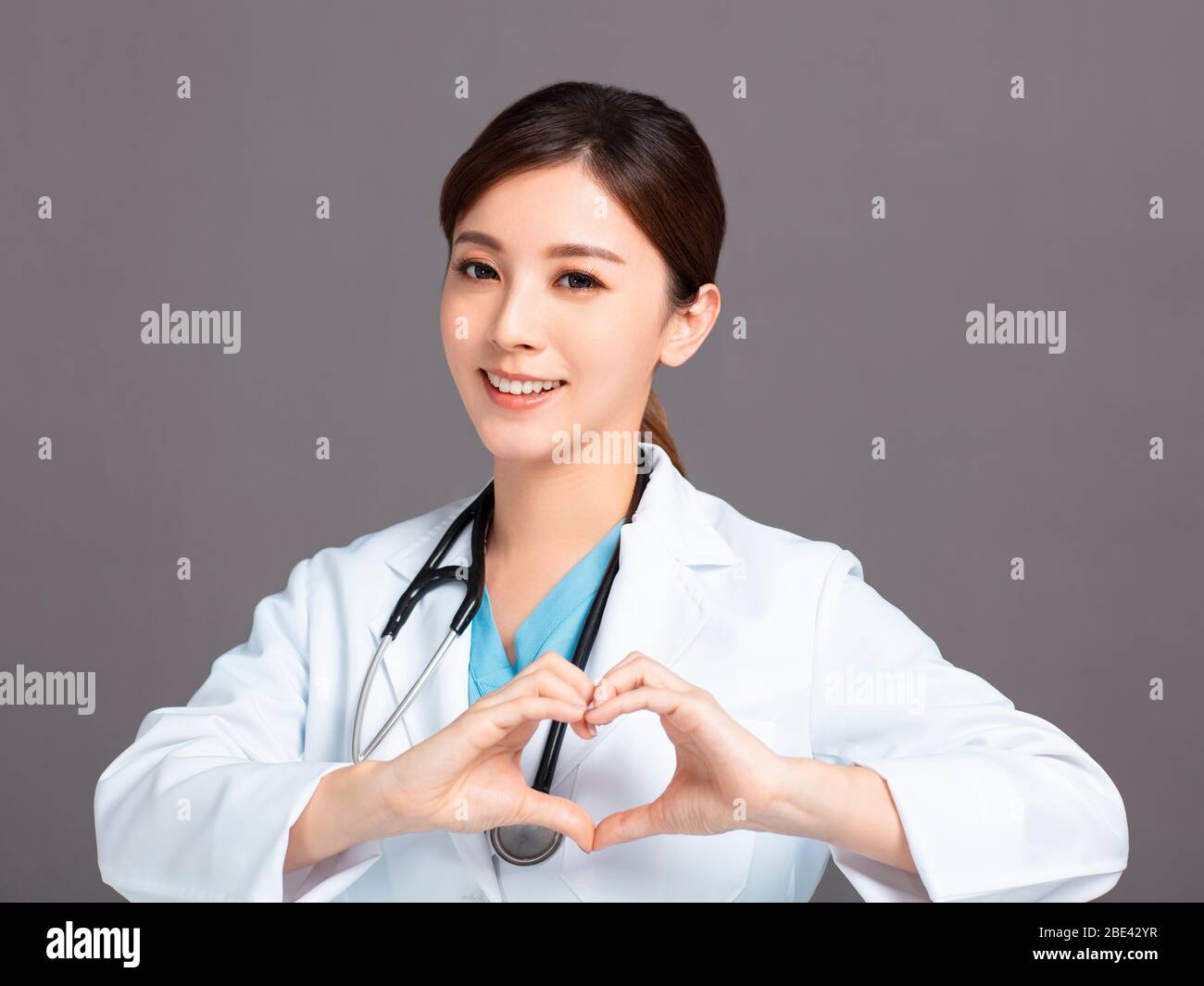 female smiling cheerful health care doctor hand making heart sign Stock ...