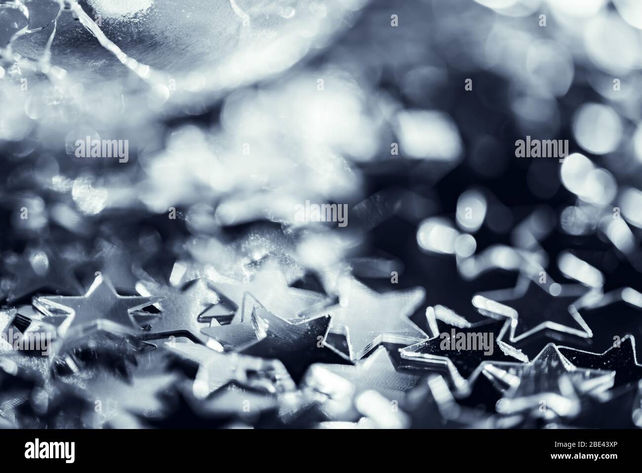 Macro photo of bright silver star and cracked glass sphere with light ...