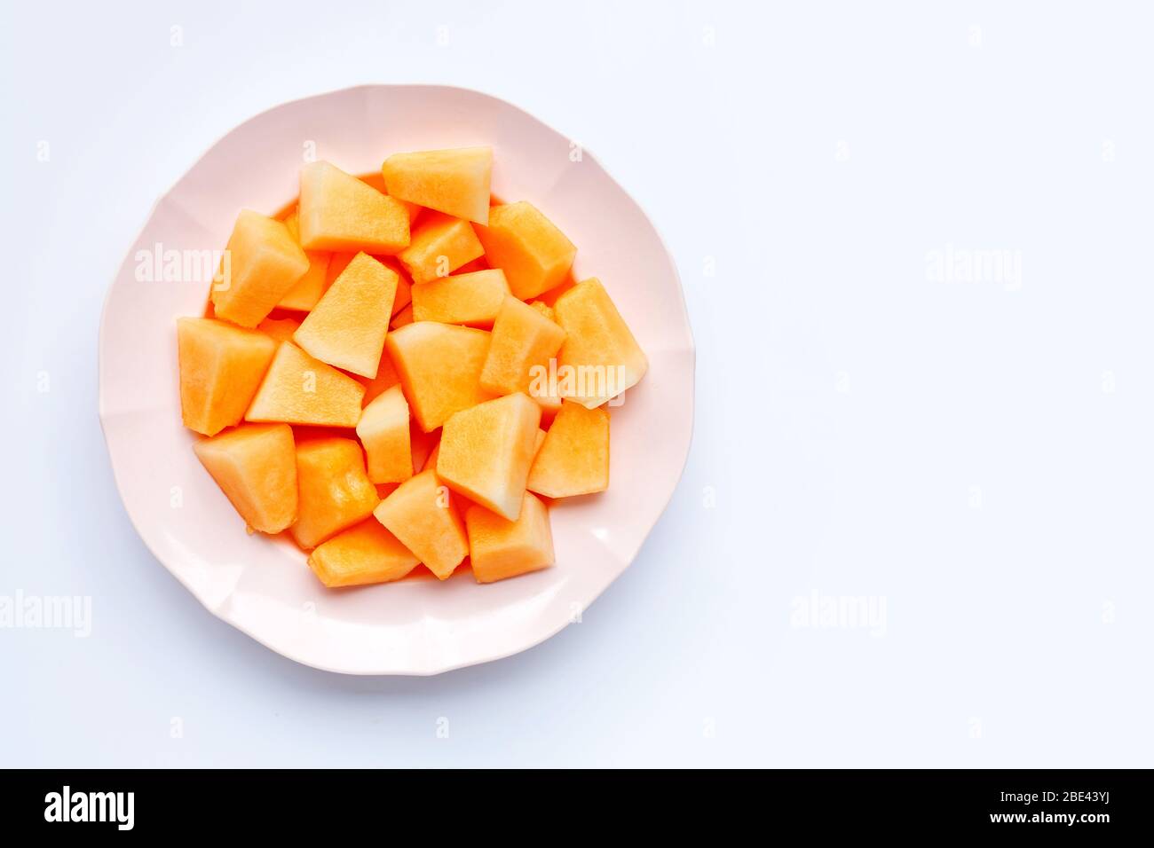 Sliced melon in dish on white background. Top view Stock Photo - Alamy