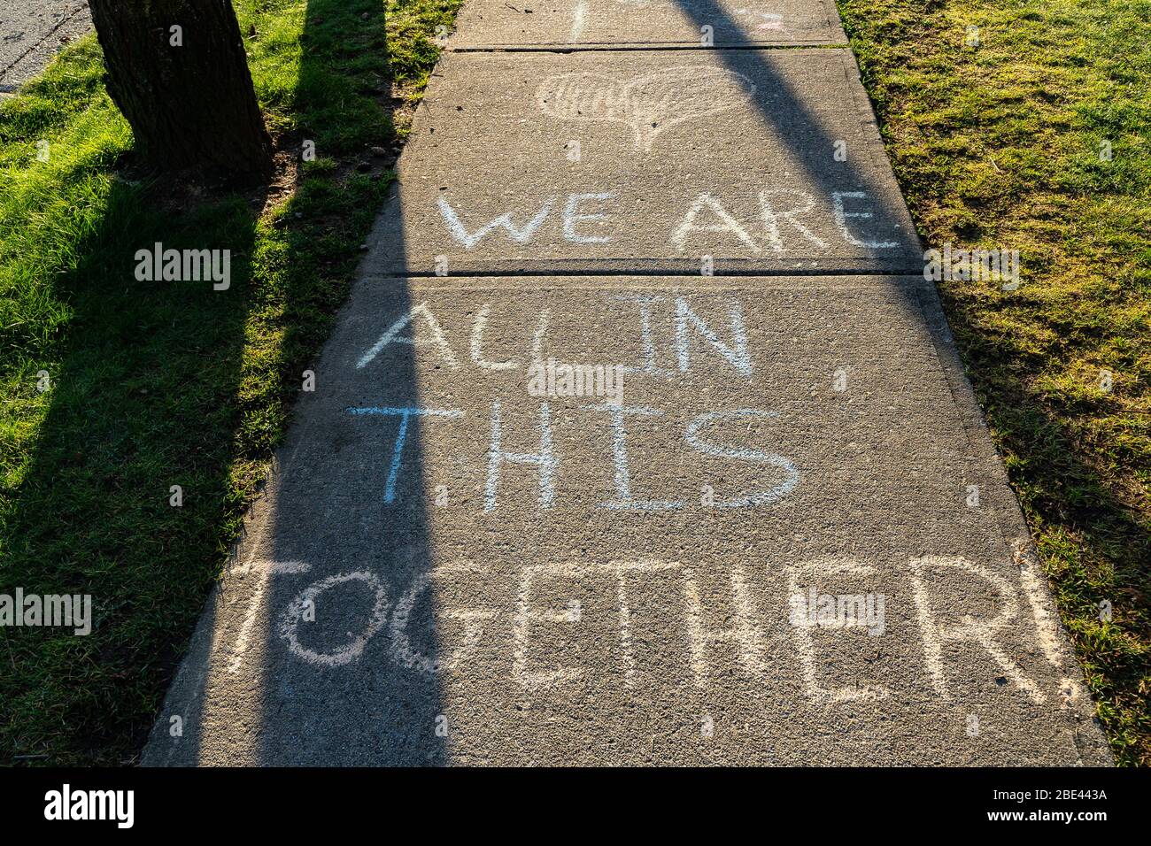 Uplifting chalk messages on the sidewalk made by children near the ...