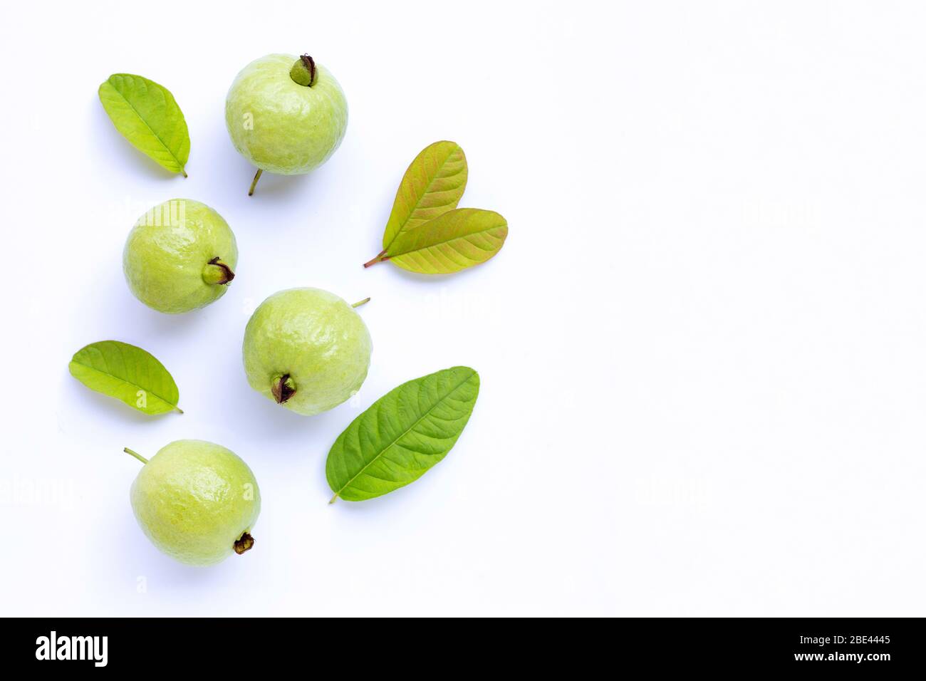 Top view of fresh ripe guava with leaves on white background. Copy ...