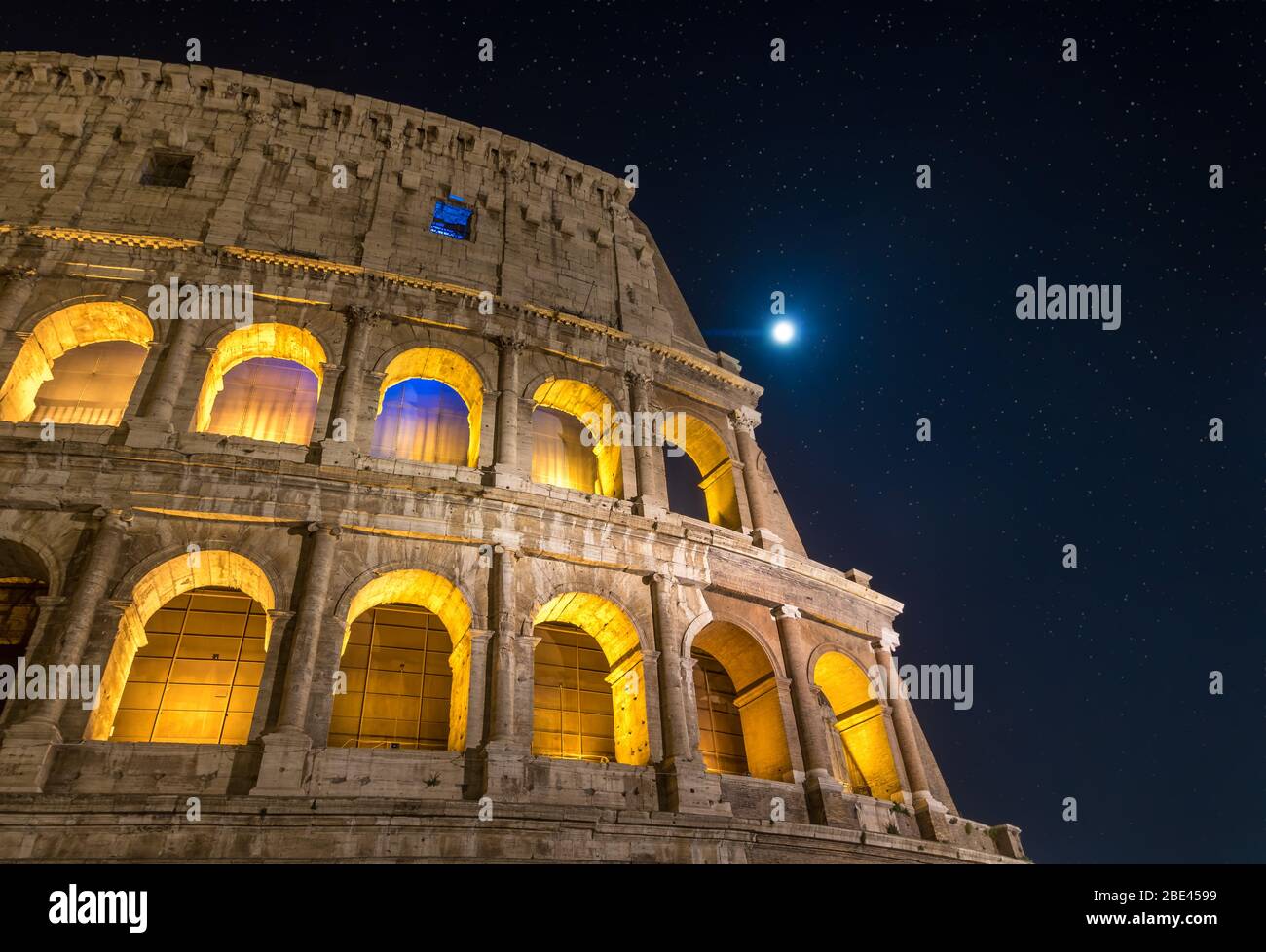 Roman Colosseum Illuminating at Night under a Bright Full Moon and ...