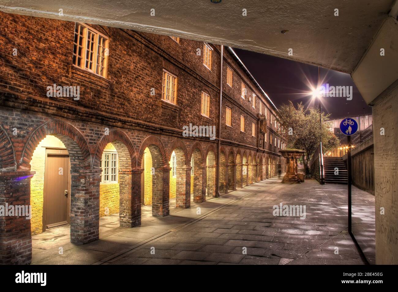 Traditional Red Brick Building with Arcade along Quiet Street At Night ...