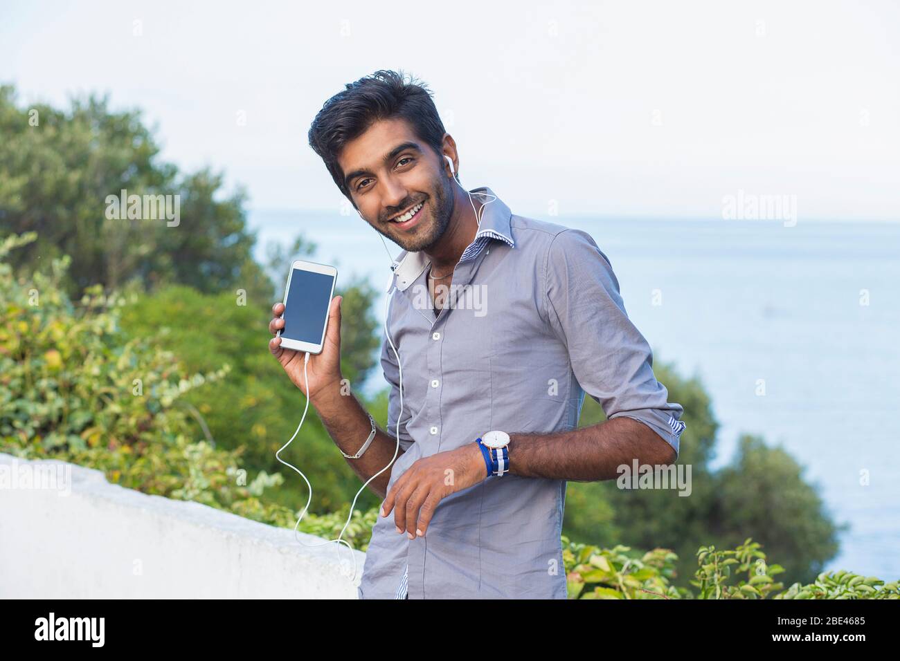 Closeup happy smiling indian man showing mobile phone. People and ...