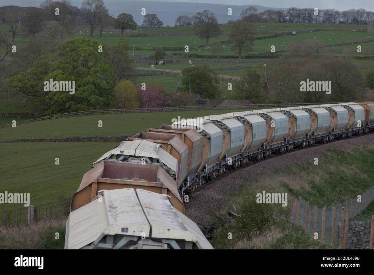 Railfreight wagons carrying aggregate curving along the single track ...