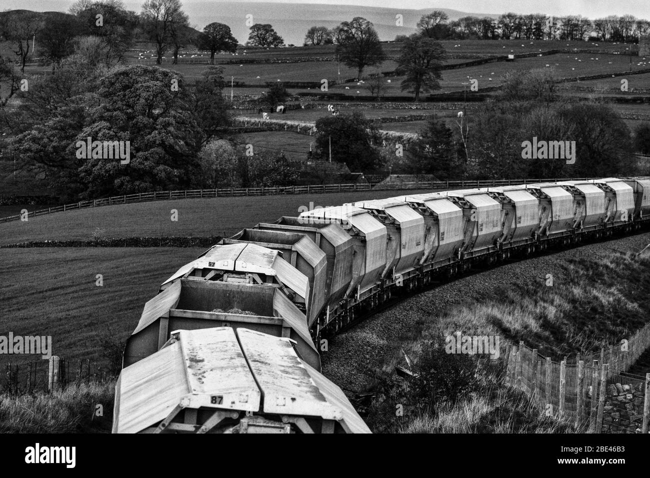 Railfreight wagons carrying aggregate curving along the single track ...