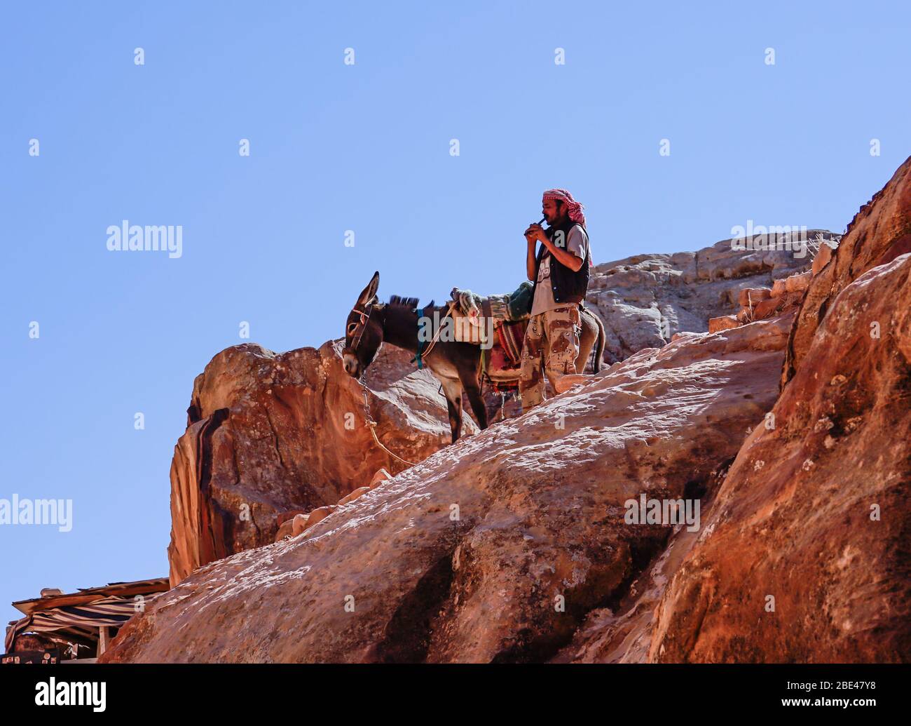 Jordan, Petra, Bedouin in traditional dress playing music on his ...
