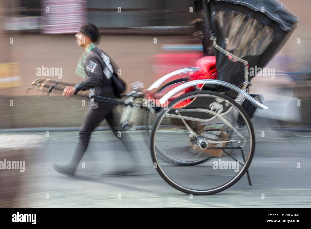 Young man pulling a rickshaw in Kyoto, Japan Stock Photo - Alamy