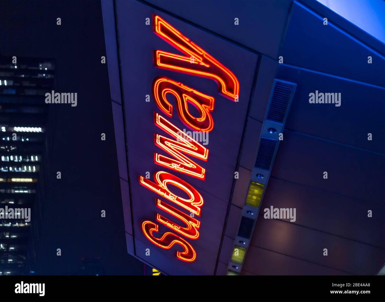 Subway sign illuminated at night in Manhattan; New York City, New York ...