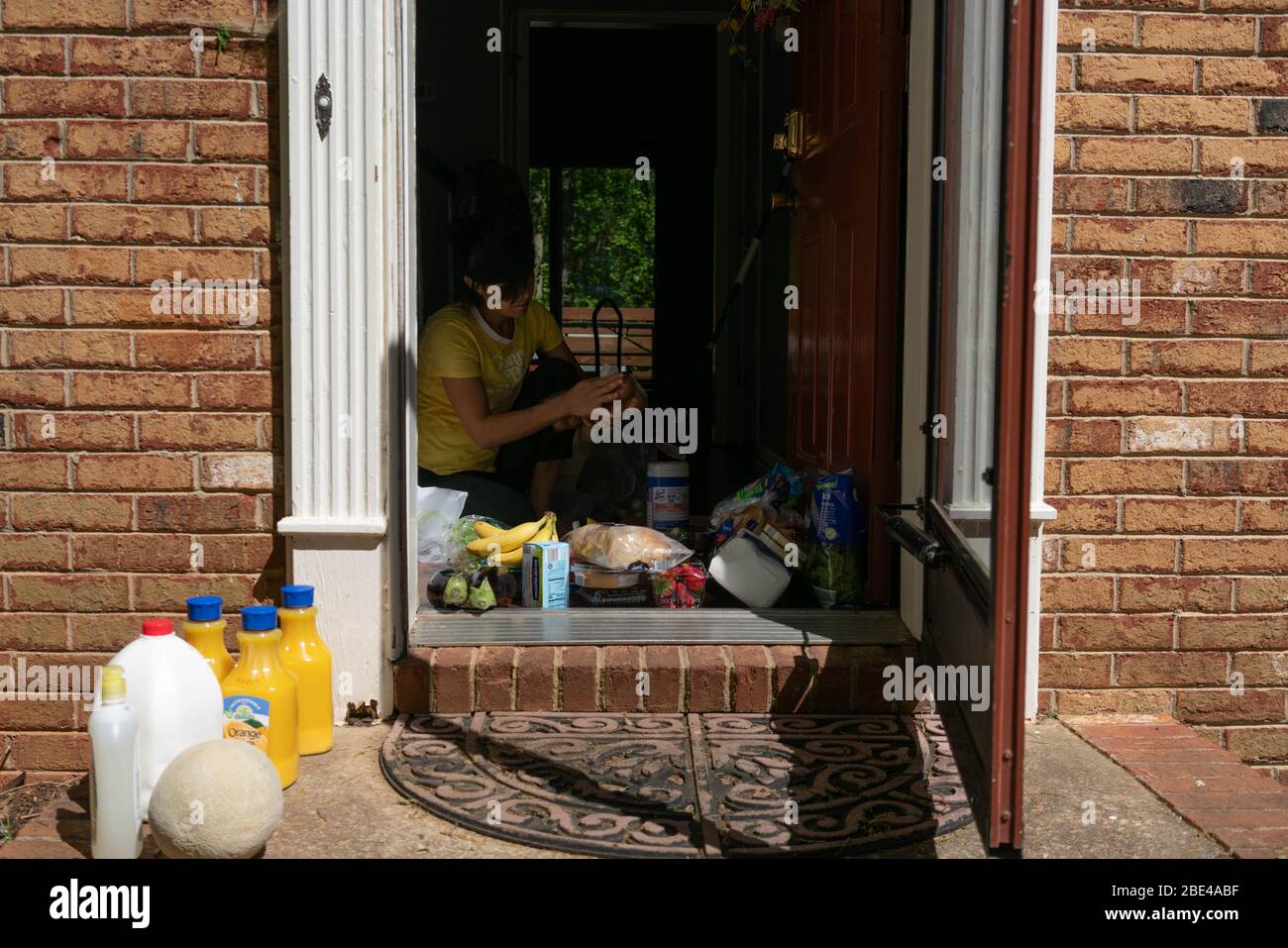Cary, NC, USA. 10th Apr, 2020. Necla D (39) is cleaning the groceries ...