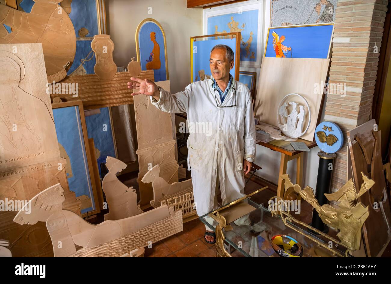 Artisan showing his handiwork of wood carvings and paintings; Venice ...