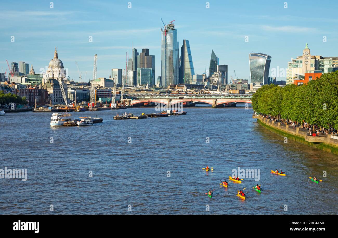 Boats on the River Thames with skyscrapers and landmarks; London ...