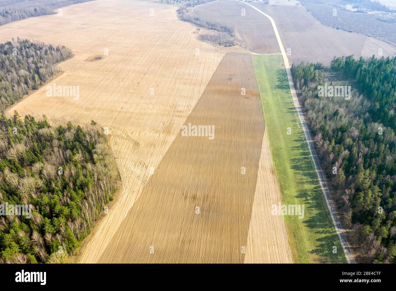 countryside landscape with empty plowed fields and country road in ...