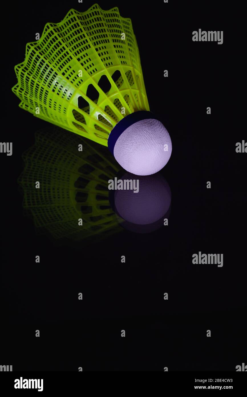 The yellow shuttlecock on the black background. Badminton shuttlecock ...