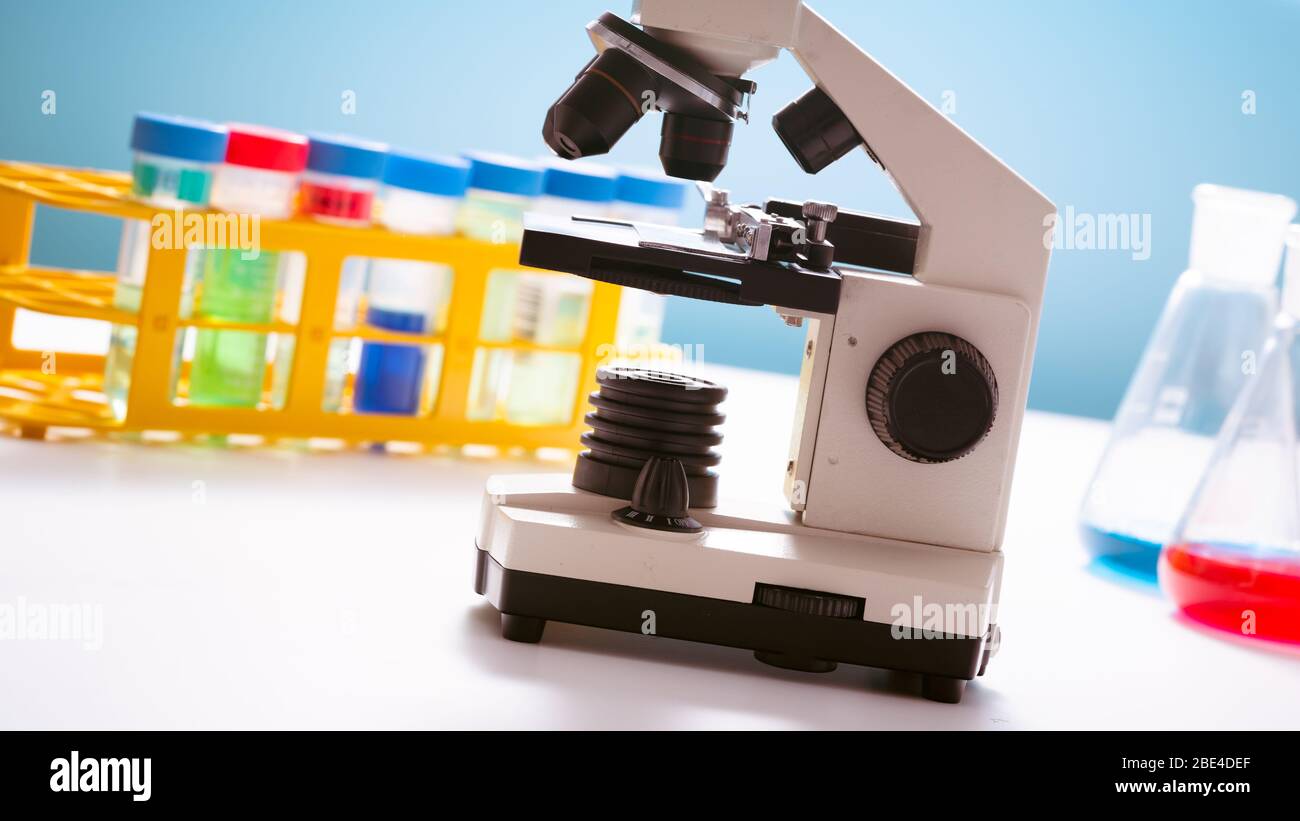 scientific experiment in school class. Microscope and test tubes on the ...