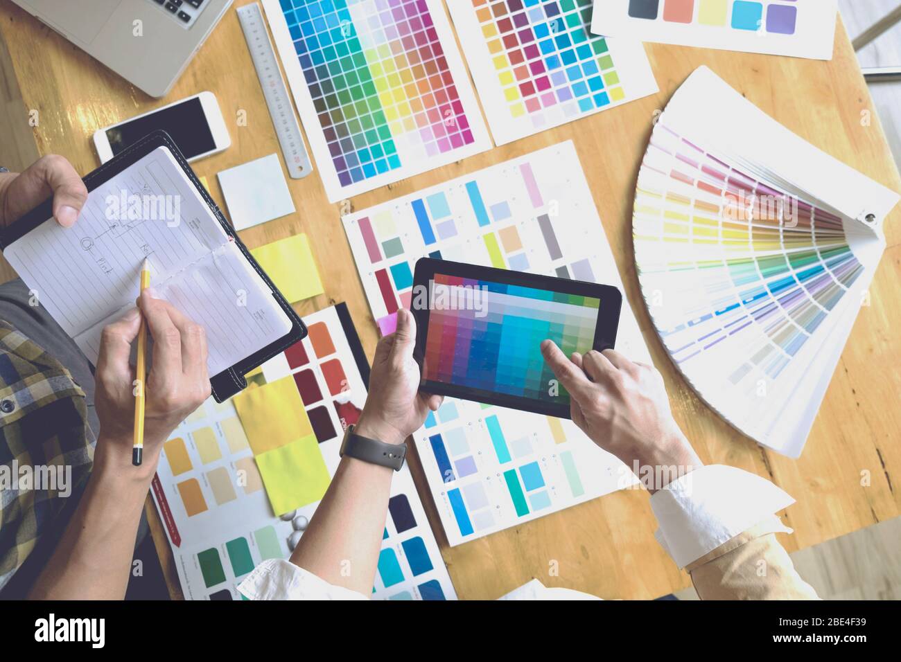 Graphic designers use the tablet to choose colors from the color bar ...