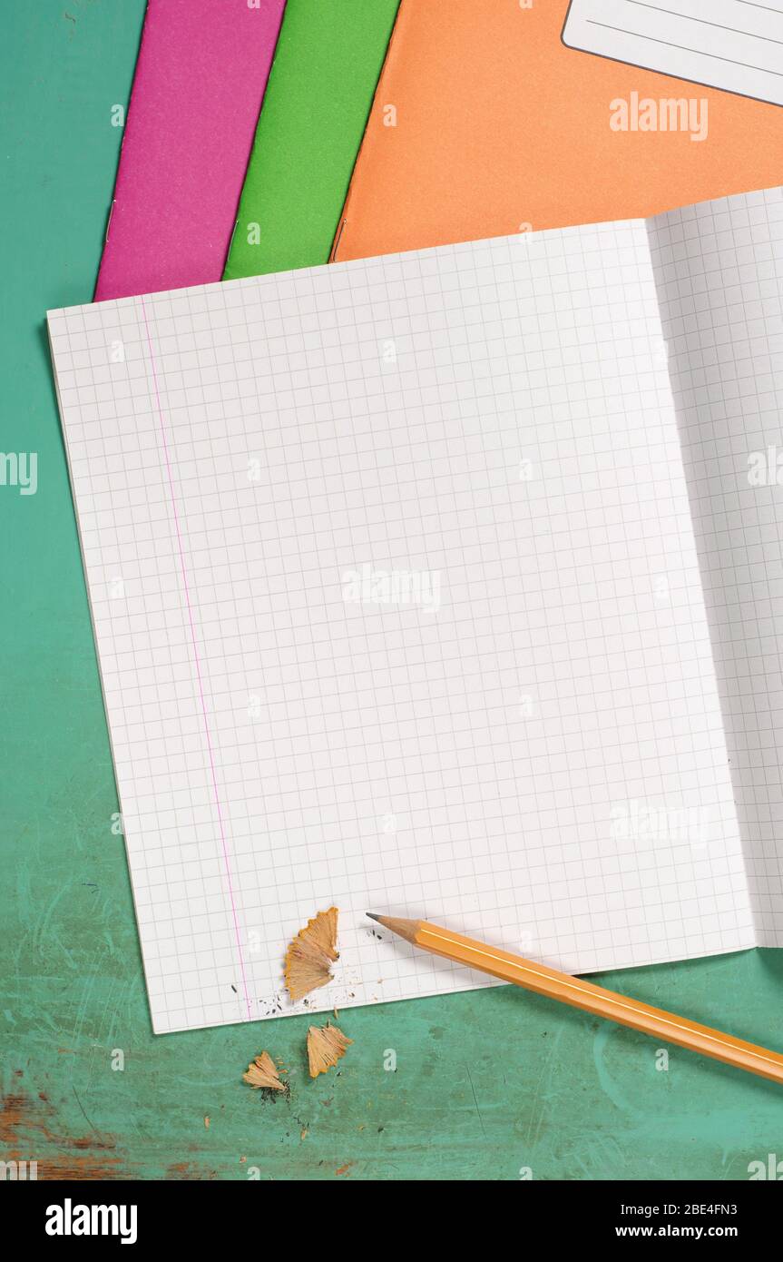 Opened school notebooks and pencils on the desk Stock Photo - Alamy