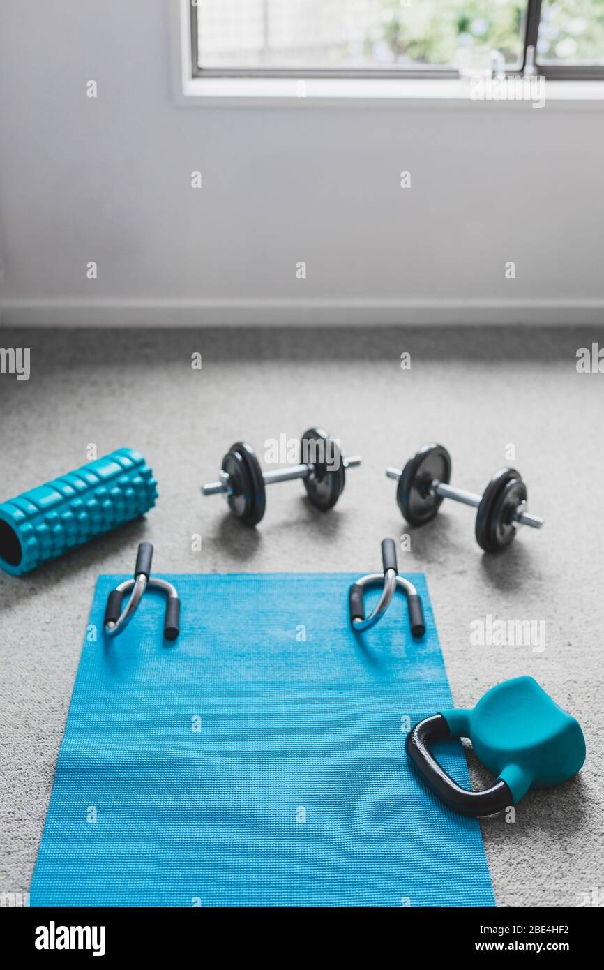 home gym concept, room with dumbbells kettlebell foam roller and push ...