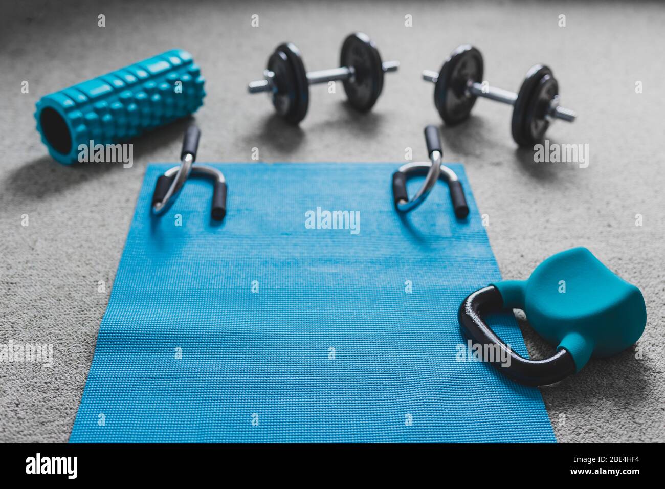 home gym concept, room with dumbbells kettlebell foam roller and push ...