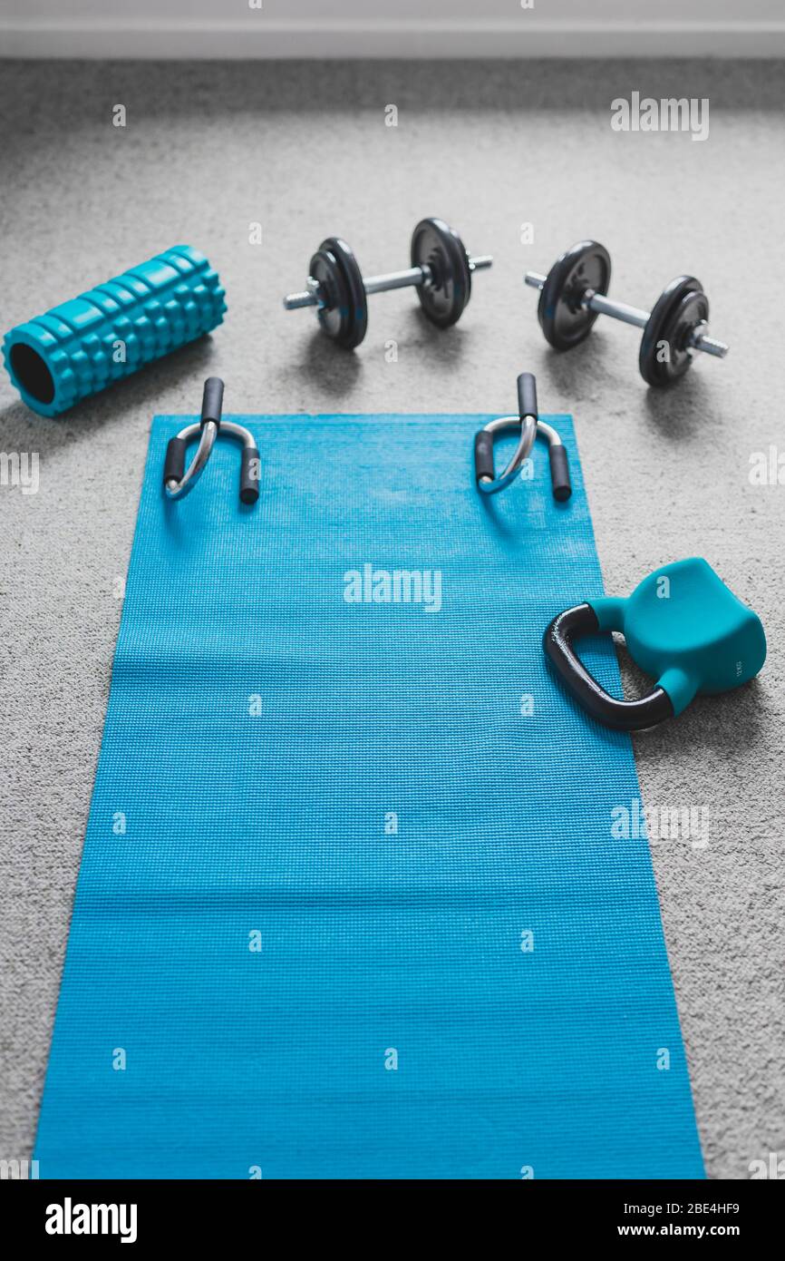 home gym concept, room with dumbbells kettlebell foam roller and push ...