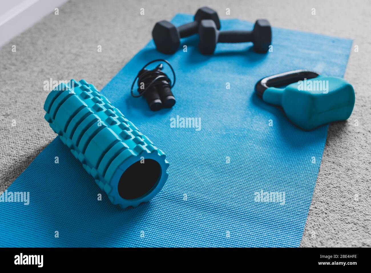 home gym concept, room with dumbbells kettlebell foam roller and push ...