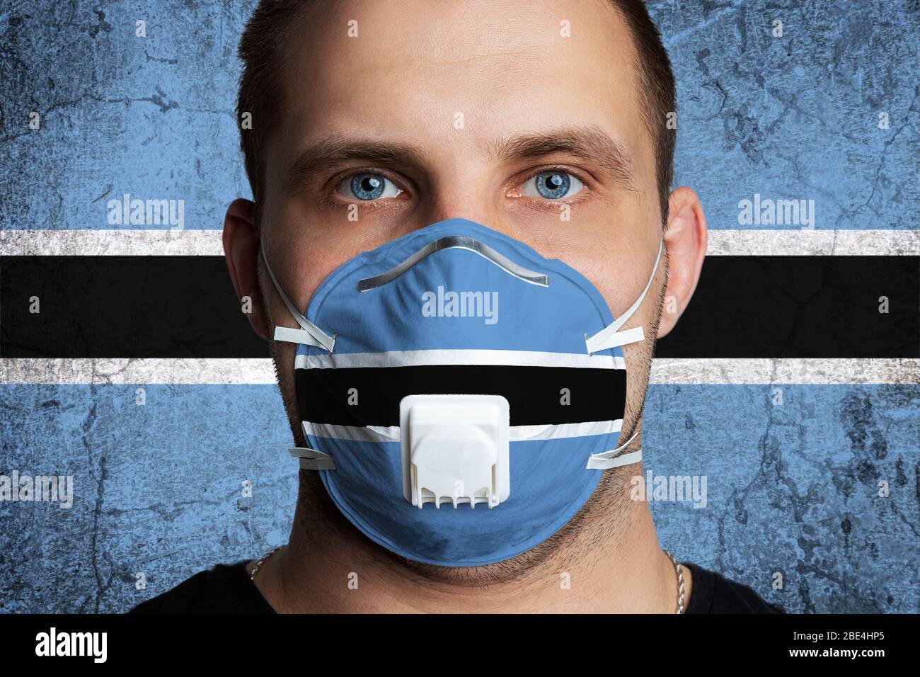 Young man with sore eyes in a medical mask painted in the colors of the ...