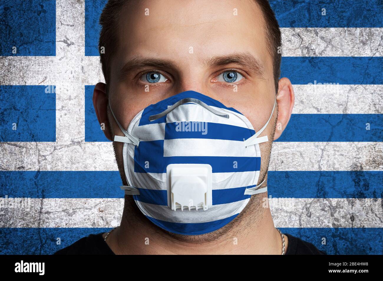 Young man with sore eyes in a medical mask painted in the colors of the ...