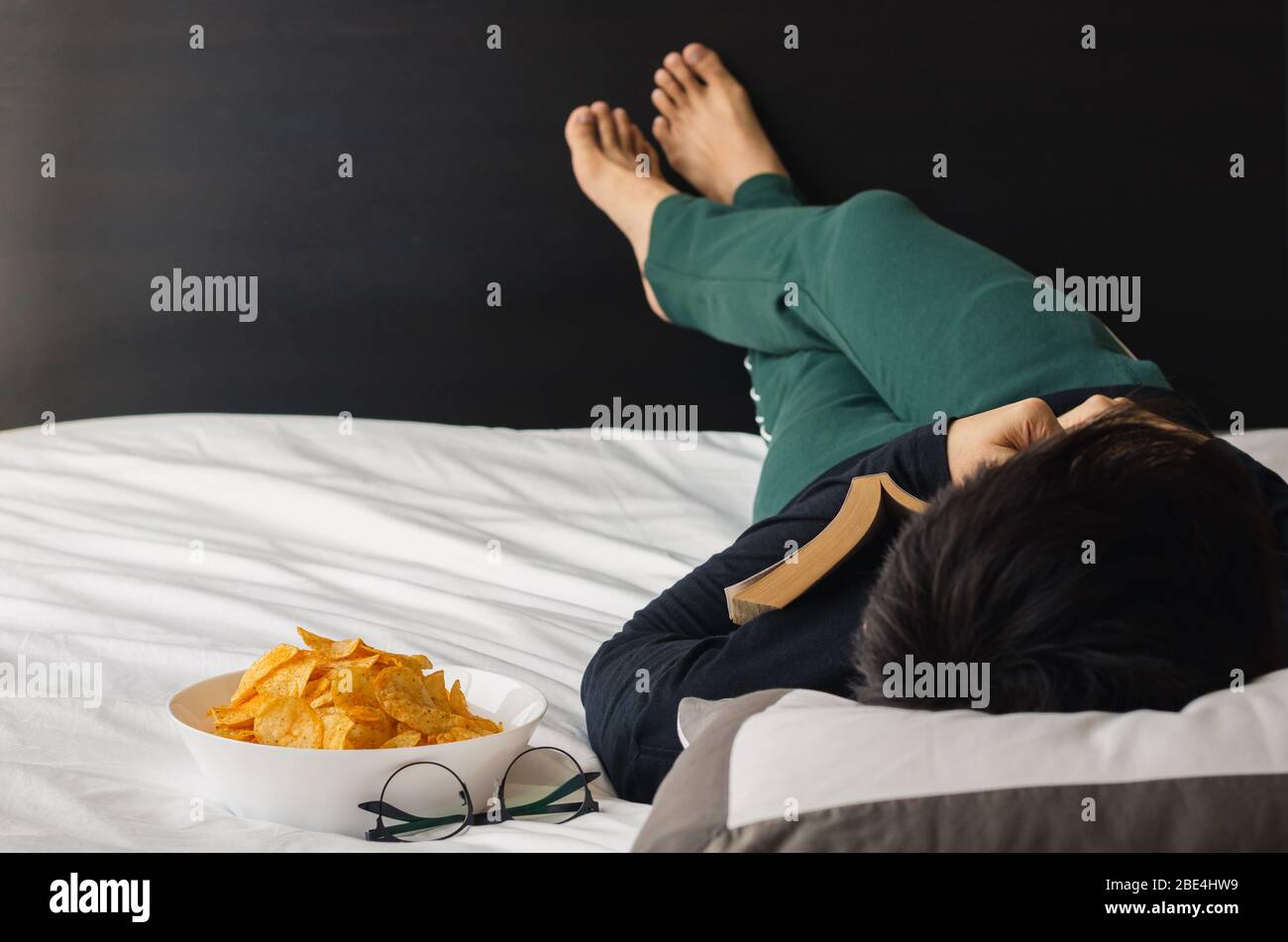 Potato Chips in white bowl put on bed for snack when relaxing on bed ...