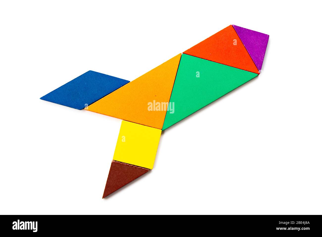 Color wood tangram puzzle in rocket or missile shape on white ...