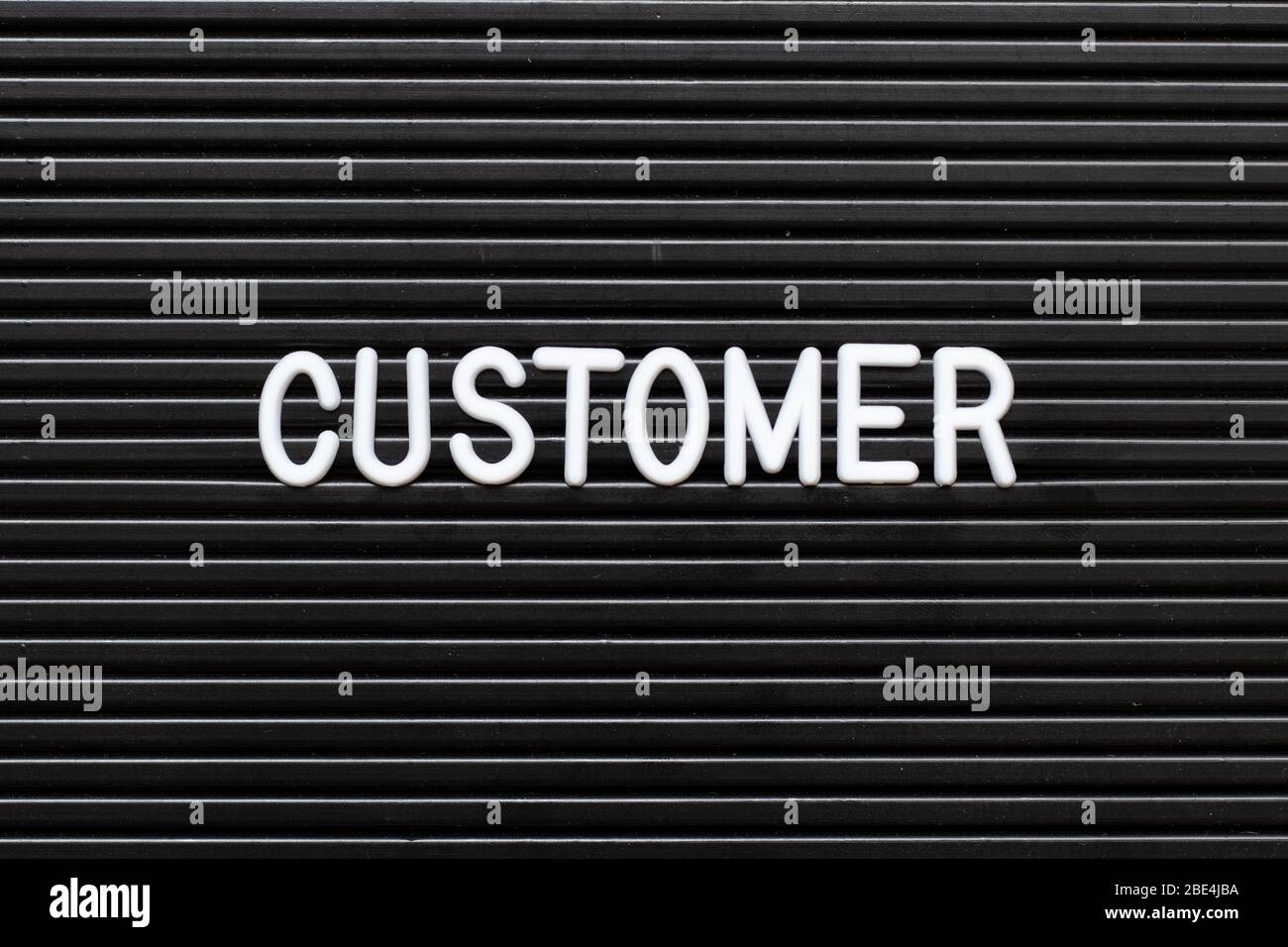 Black felt board with white alphabet in word customer background Stock ...