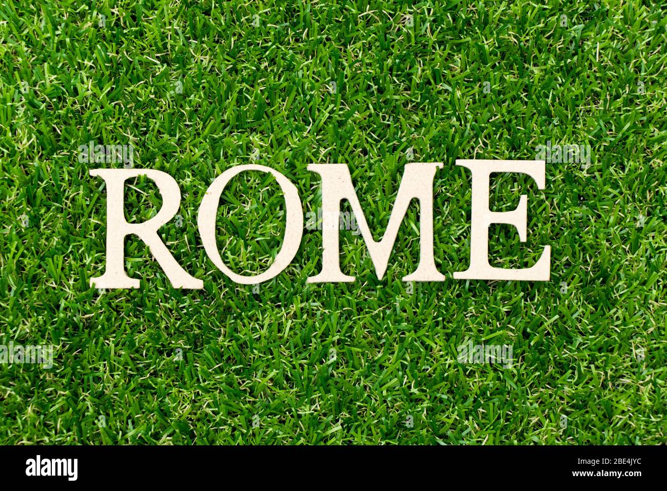 Wood letter in word Rome on green grass background Stock Photo - Alamy