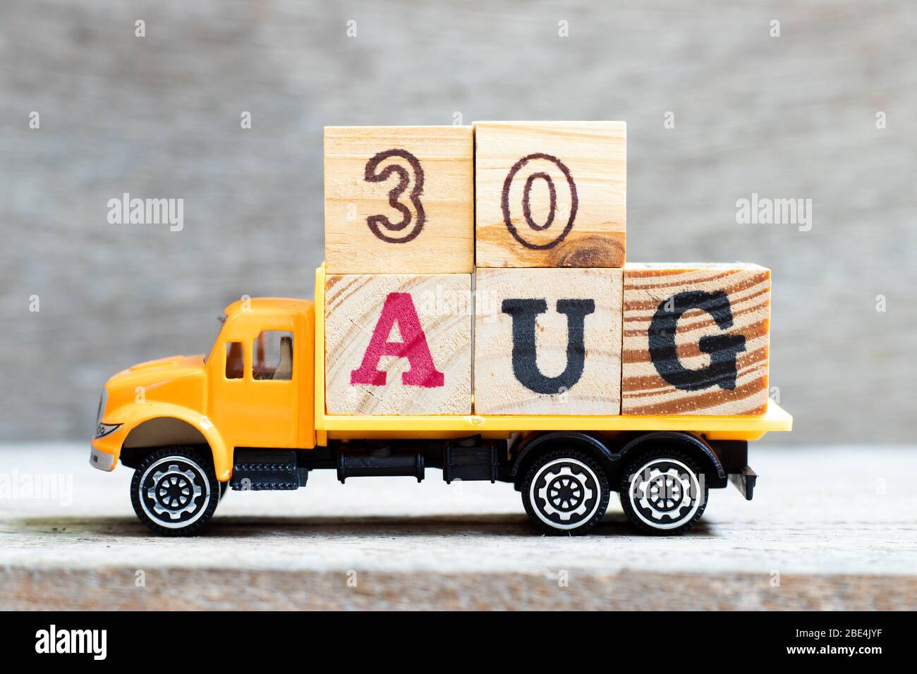 Truck hold letter block in word 30aug on wood background (Concept for ...