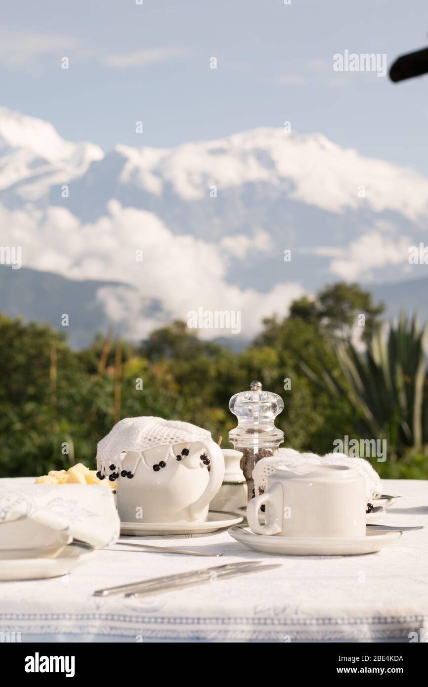 Breakfast table setting on a viewpoint terrace, with the Annapurna ...
