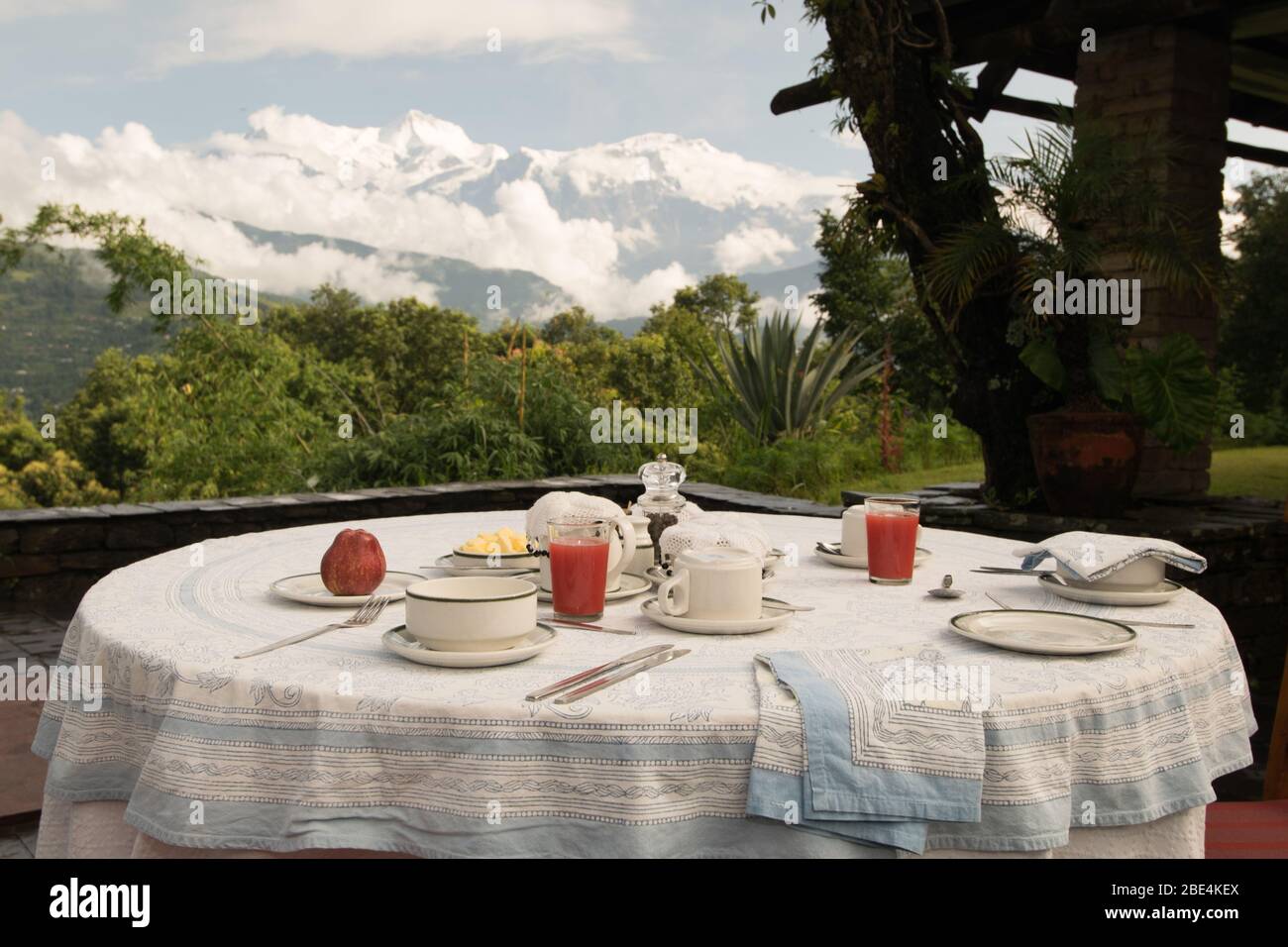 Breakfast table setting on a viewpoint terrace, with the Annapurna ...
