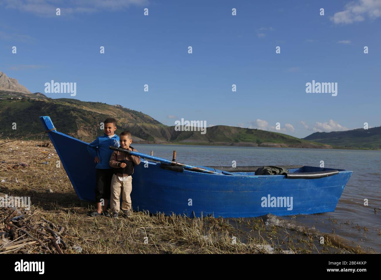 two young boys sat on colourfully painted fishing boat Stock Photo - Alamy