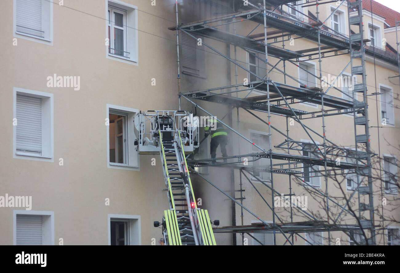 Fire brigade with breathing apparatus standing on fire ladder Stock ...