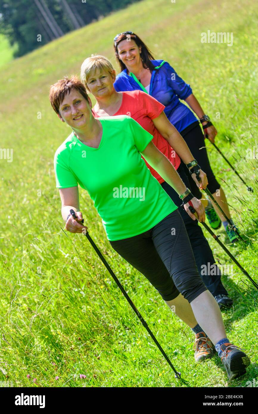 Fitness workout in green nature with nordic walking exercises Stock ...