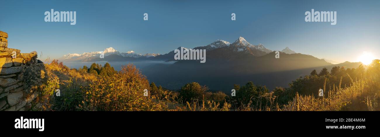 Sun rising over the Himalayas, with the Annapurna mountain range and ...