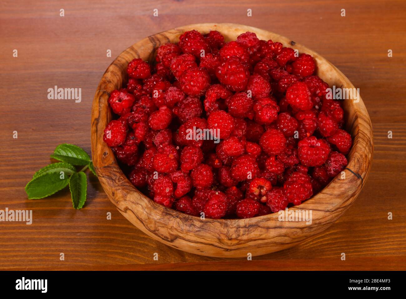 Wild raspberry in the wooden bowl Stock Photo - Alamy