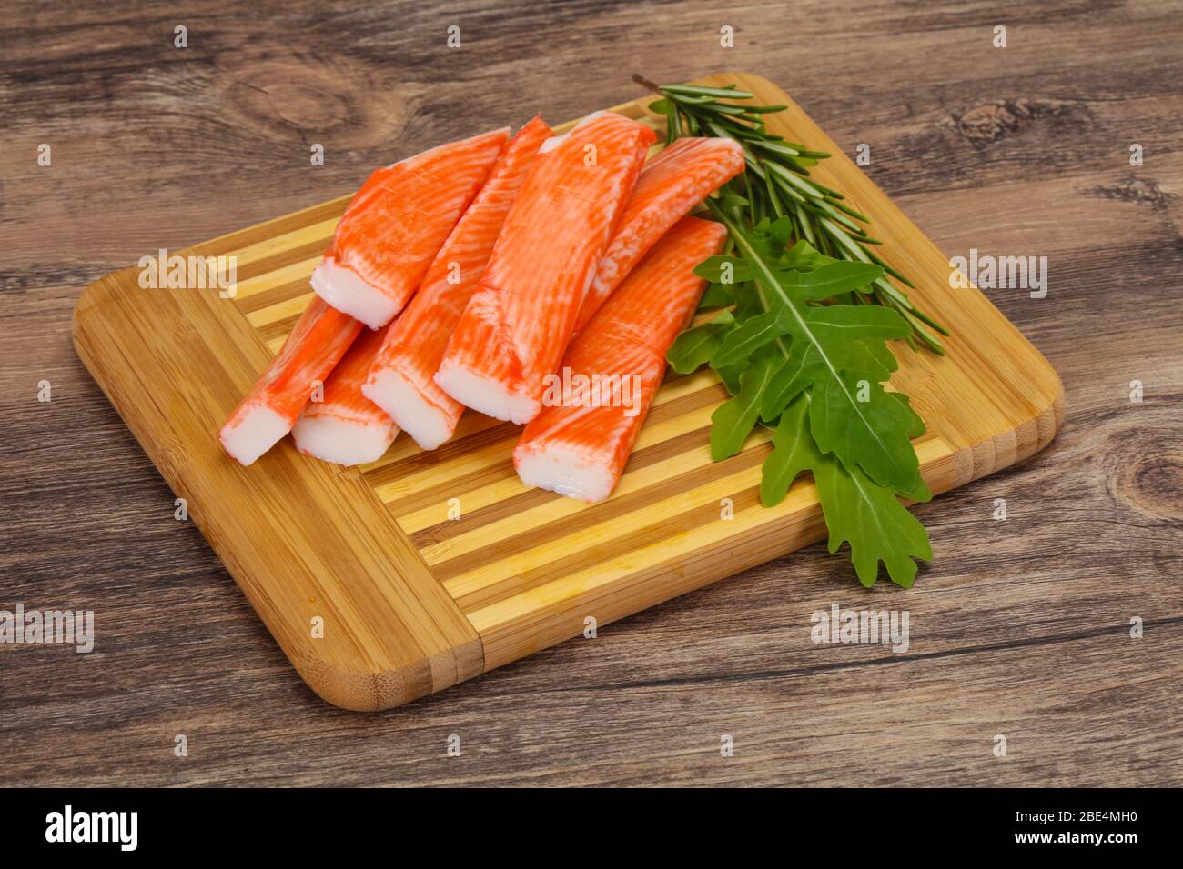 Crab stick surimi over wooden board Stock Photo - Alamy