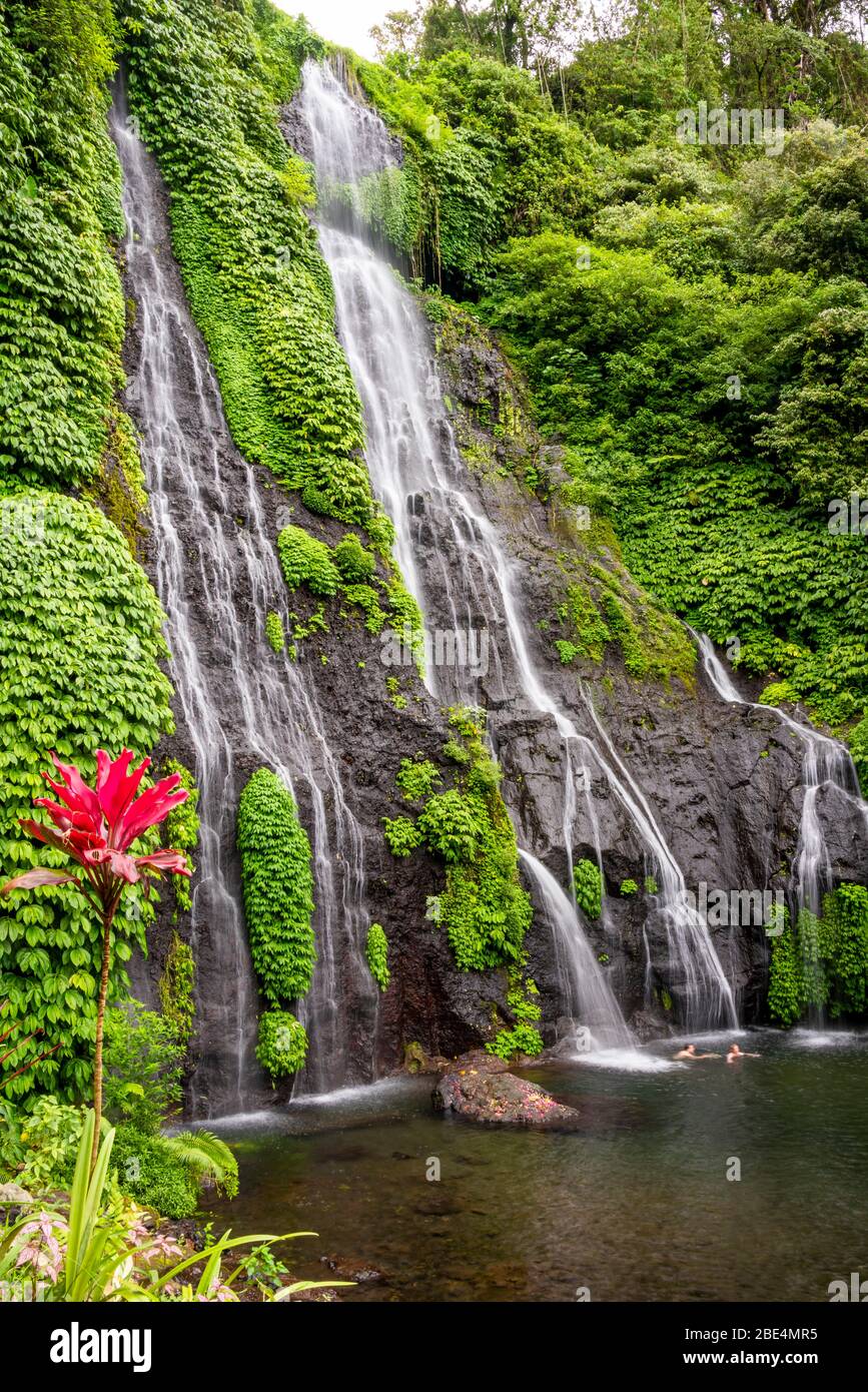 Vertical view of tourists enjoying the Banyumala Waterfalls in Bali ...