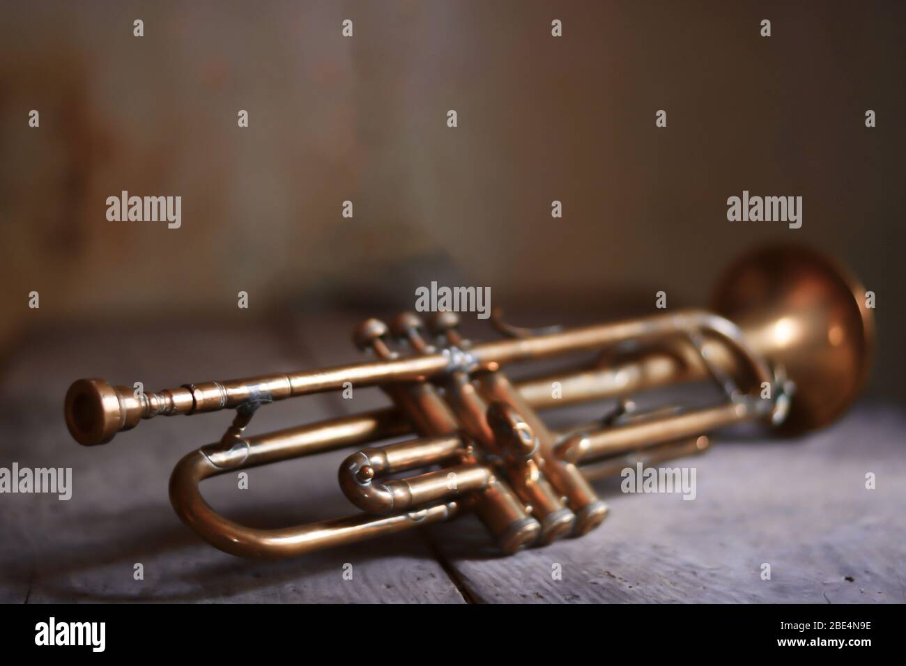 an ancient Jazz trumpet on an old wooden table Stock Photo - Alamy