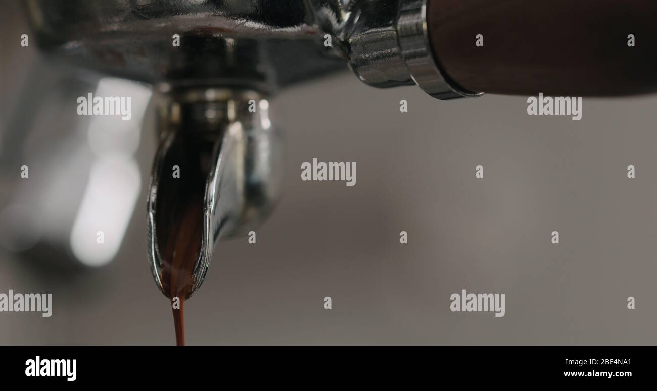 pulling espresso shot with single spout portafilter from coffee machine ...