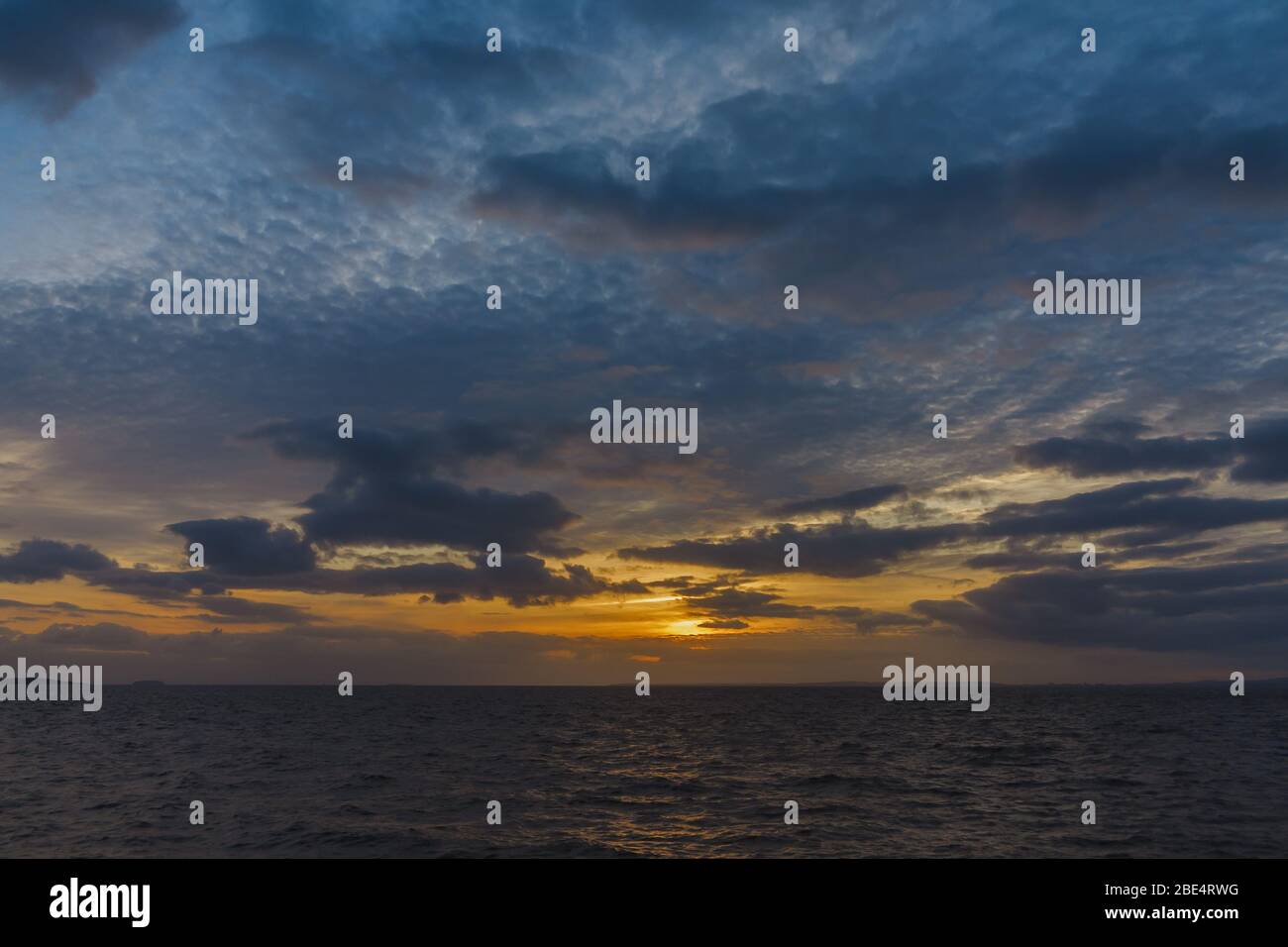 The sun about to set over the horizon Stock Photo - Alamy